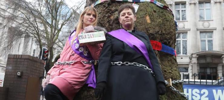 London vicar chains herself to tree in train line protest