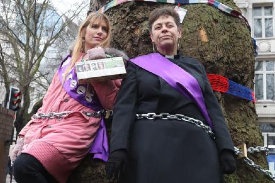 London vicar chains herself to tree in train line protest