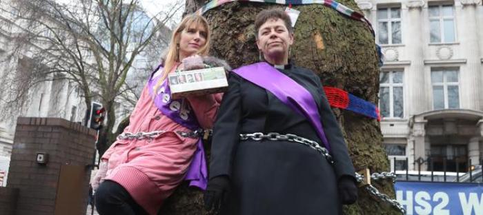 London vicar chains herself to tree in train line protest