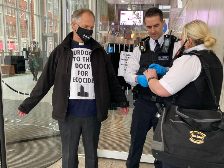 Retired vicar arrested and charged after glueing himself to News UK ...